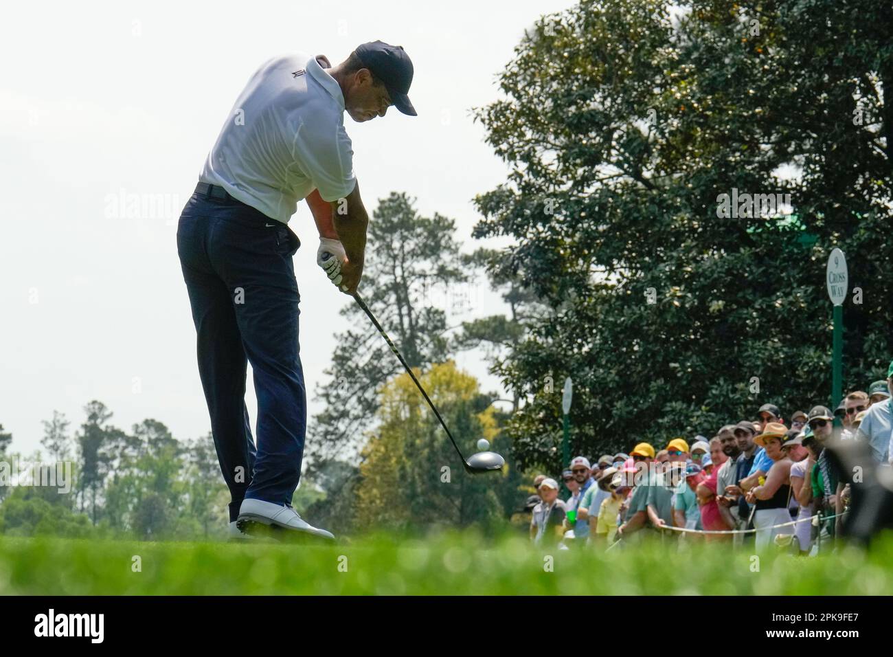 Tiger Woods hits his tee shot on the ninth hole during the first round ...