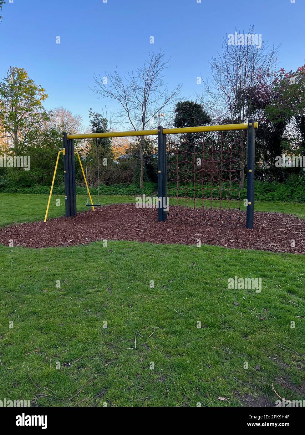 Swing and climbing net on children's playground in park Stock Photo - Alamy