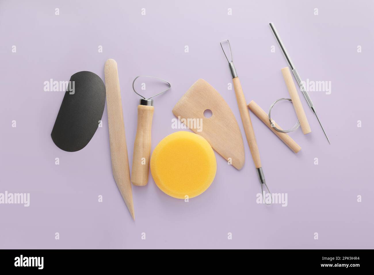 Set of clay modeling tools on pale violet background, flat lay Stock ...