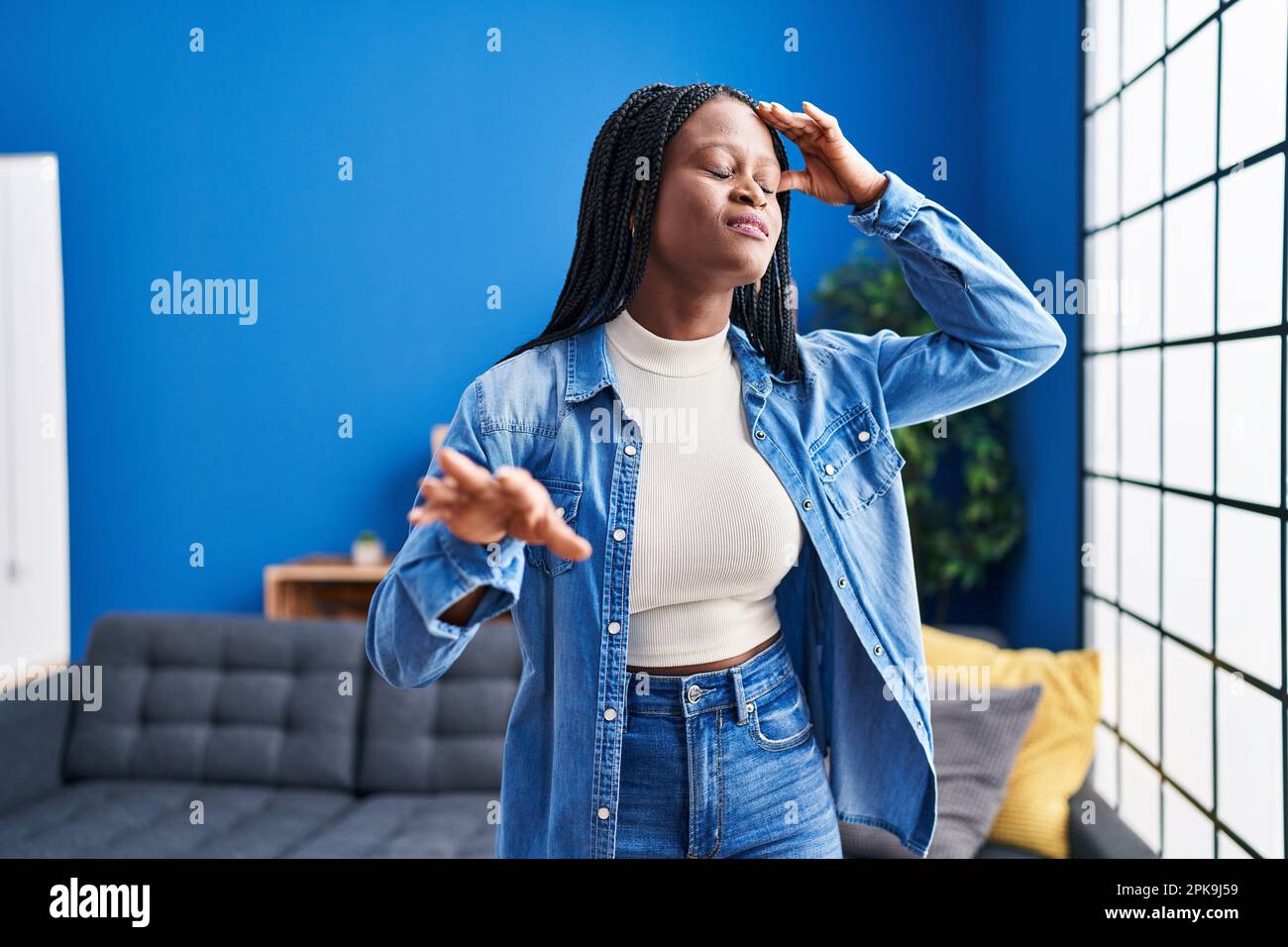 African american woman suffering dizzy standing at home Stock Photo - Alamy