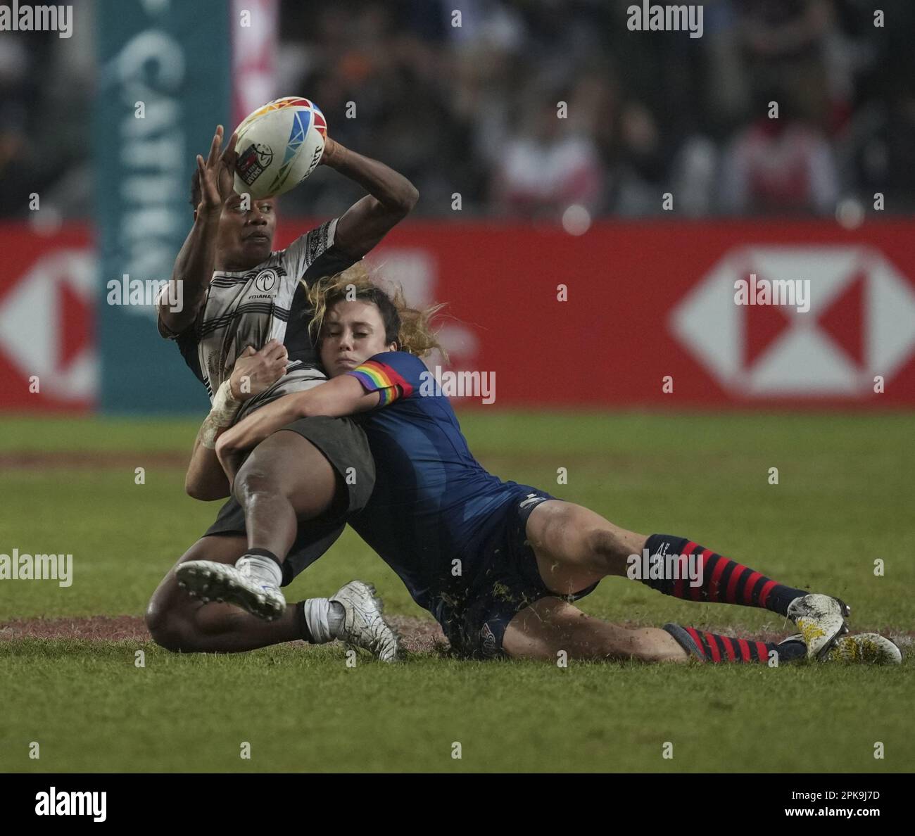 FijiHH Ilisapeci Delaiwau off loads the ball as she is tackled by Abbie ...