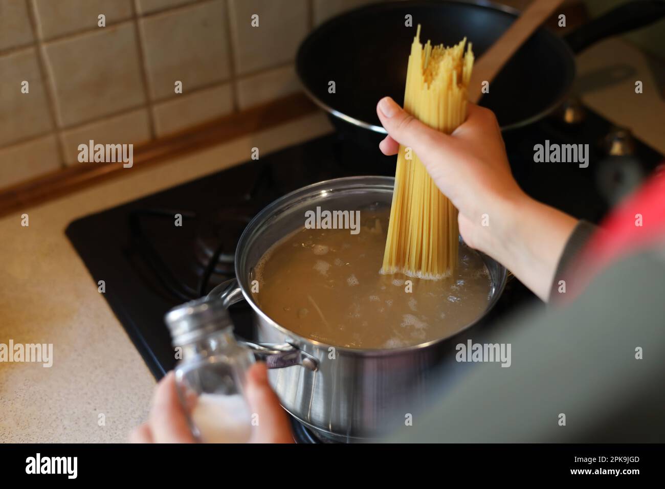 The girl is cooking spaghetti hi-res stock photography and images - Alamy