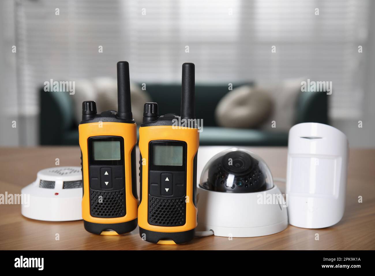 CCTV camera, walkie talkies, smoke and movement detectors on wooden ...