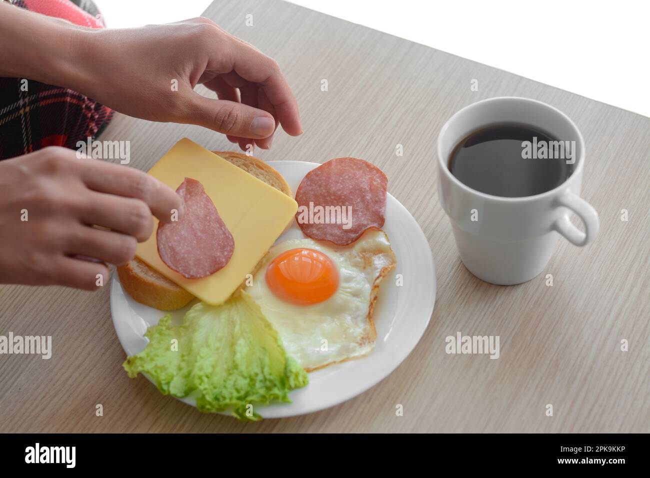 Woman preparing tasty nutritious breakfast at wooden table against ...