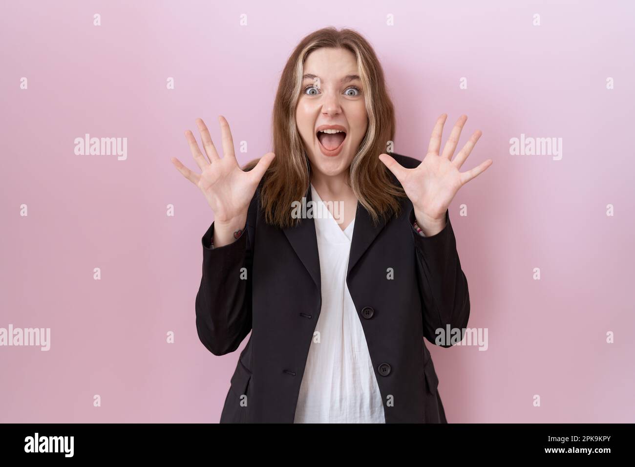Young caucasian business woman wearing black jacket celebrating mad and ...