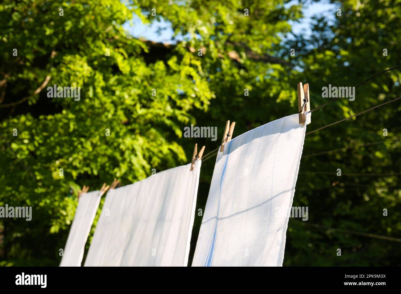 Washing line with clean laundry and clothespins outdoors Stock Photo ...