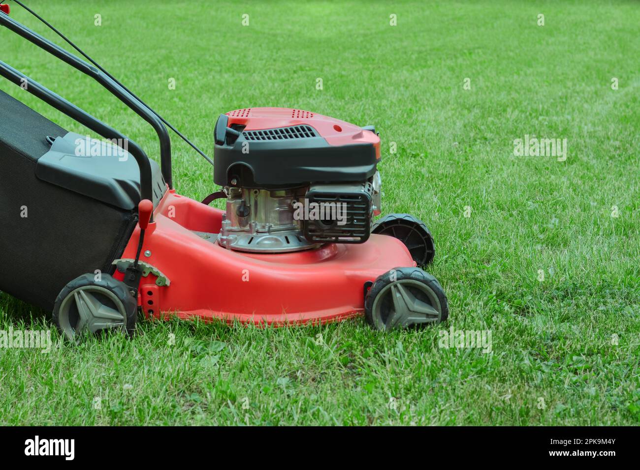 Modern garden lawn mower on green grass outdoors Stock Photo - Alamy