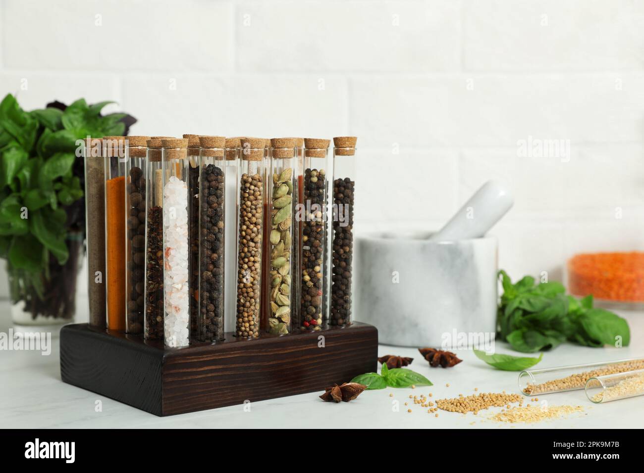Glass tubes with different spices on kitchen counter Stock Photo - Alamy