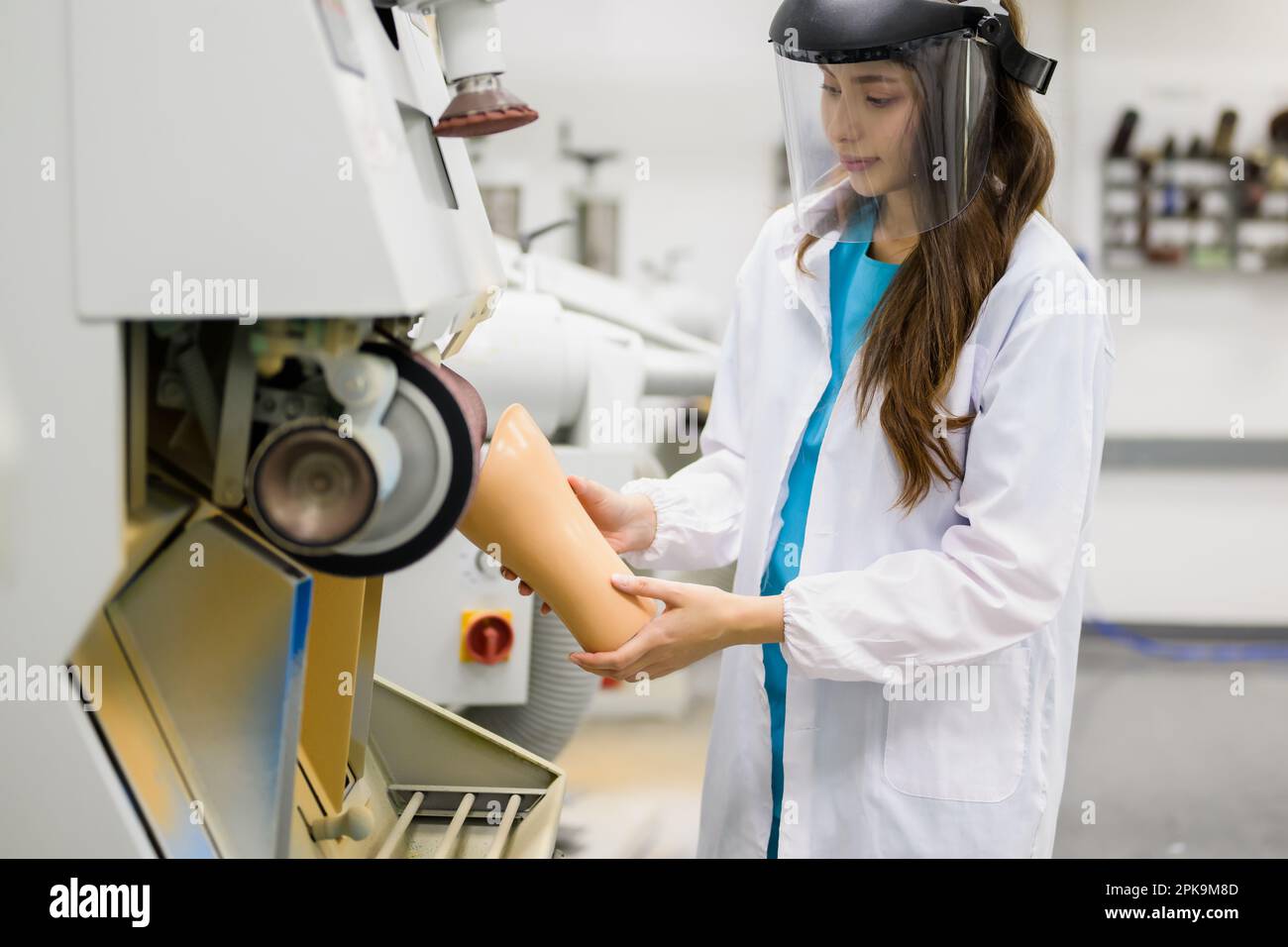 Technician making prosthetic limb using grinder to smooth socket Stock ...