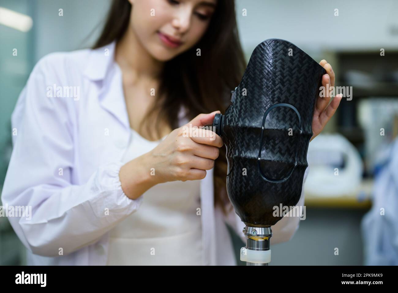 Prosthetic technician holding prosthetic leg checking and controlling ...