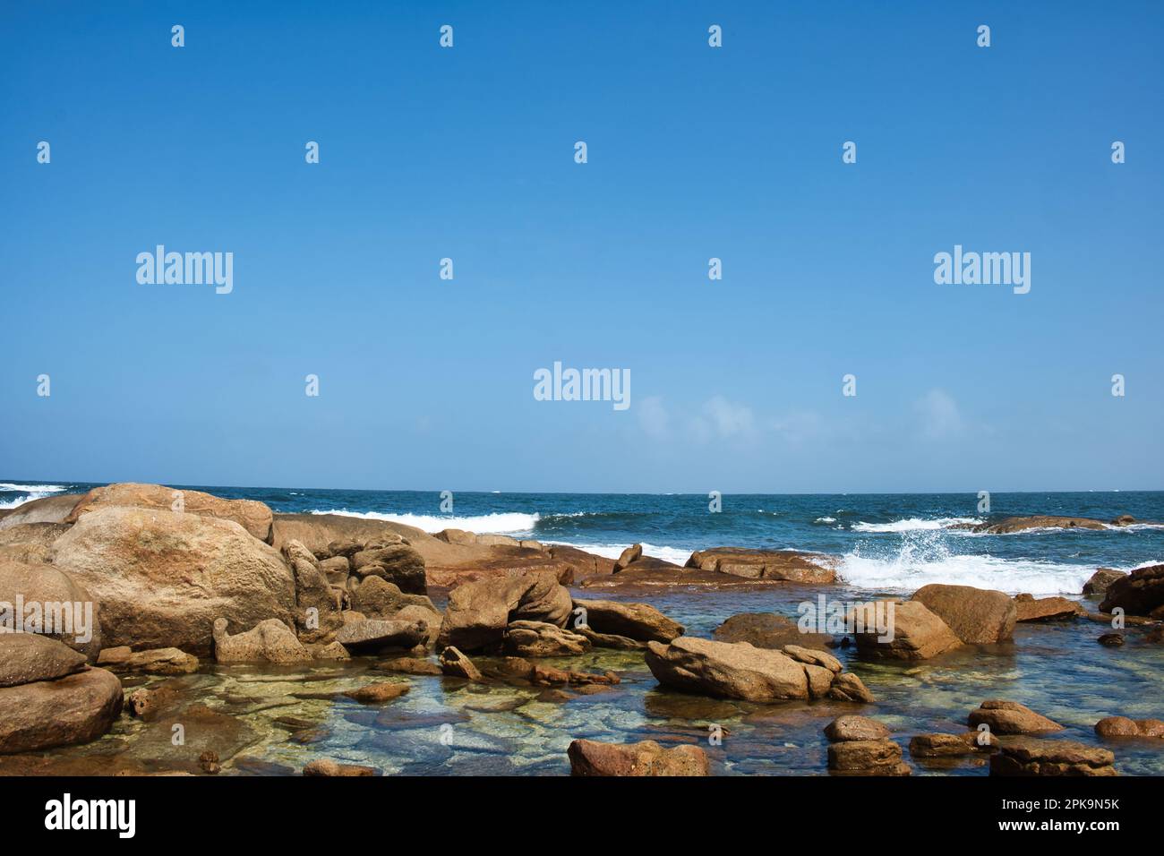 Rocky coast with eroded granite boulders, rock pools and waves at Cape ...