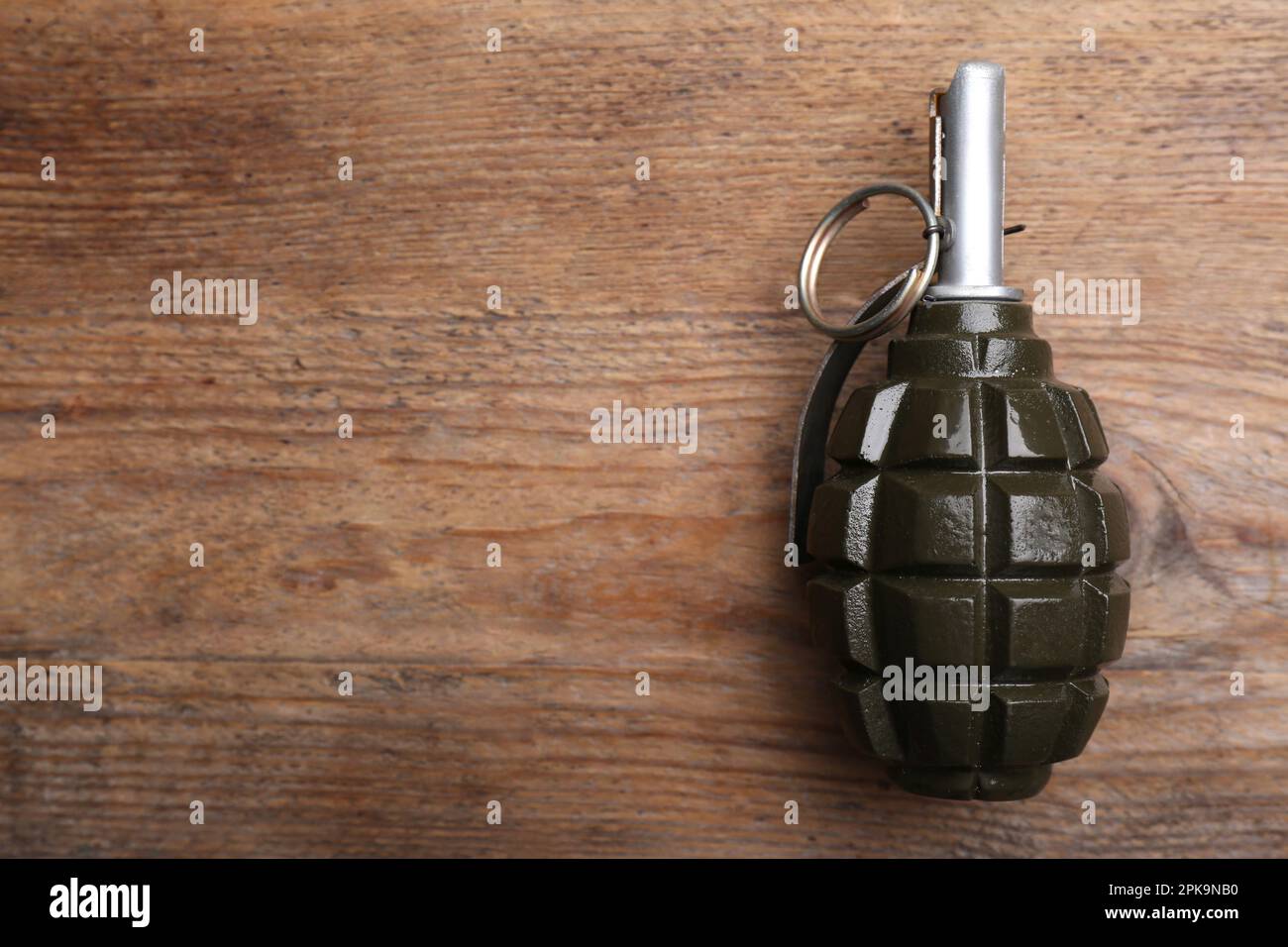 Hand grenade on wooden table, top view. Space for text Stock Photo - Alamy