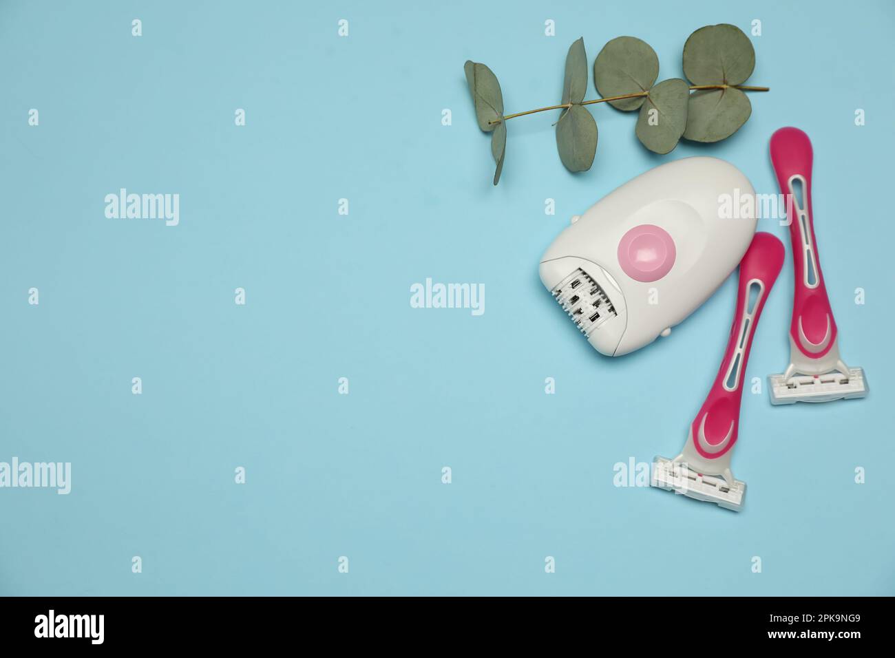 Epilator, razors and eucalyptus on light blue background, flat lay ...