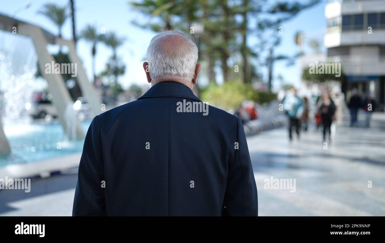 senior standing backwards at street Stock Photo - Alamy