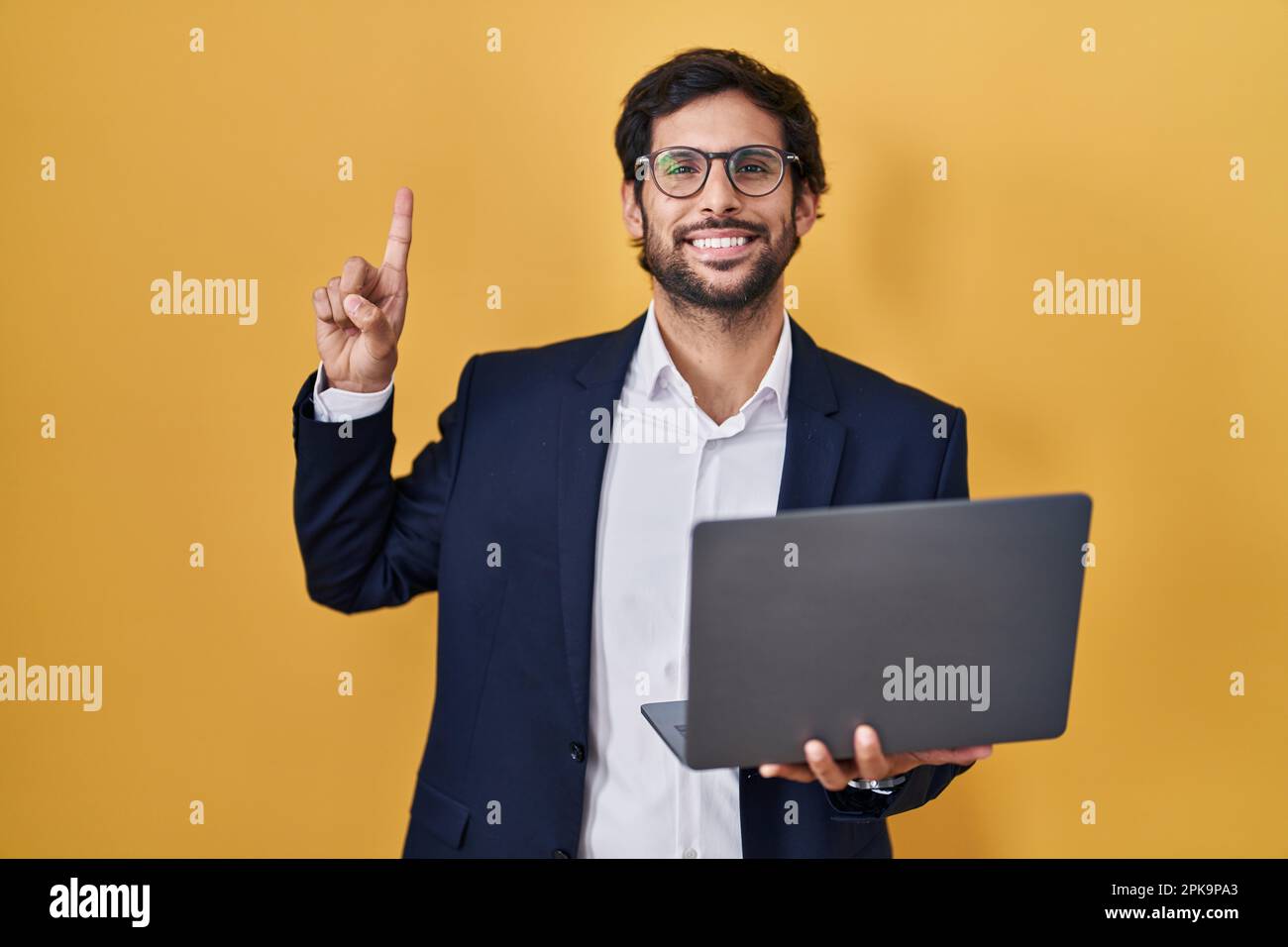 Handsome latin man working using computer laptop smiling amazed and ...