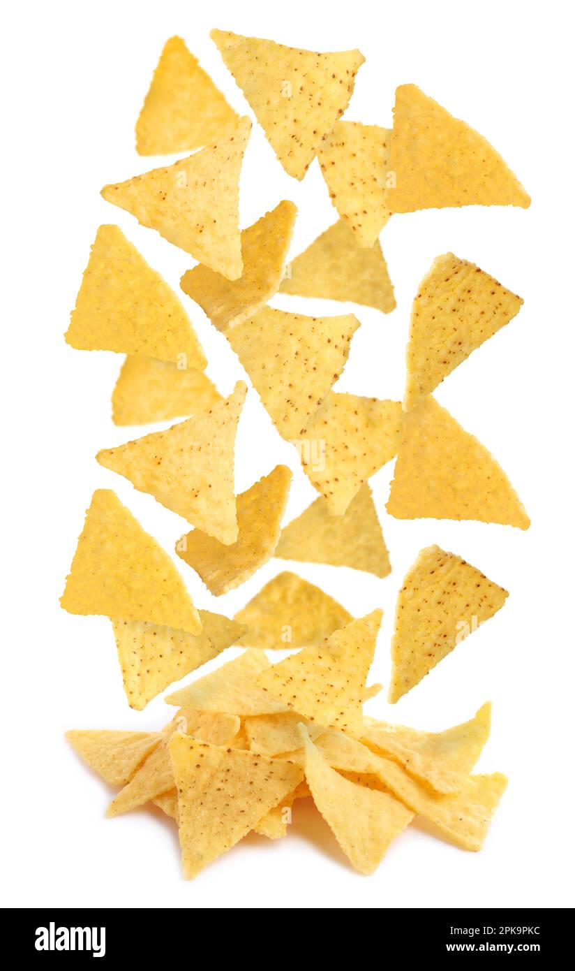 Tasty tortilla chips (nachos) falling into pile on white background ...