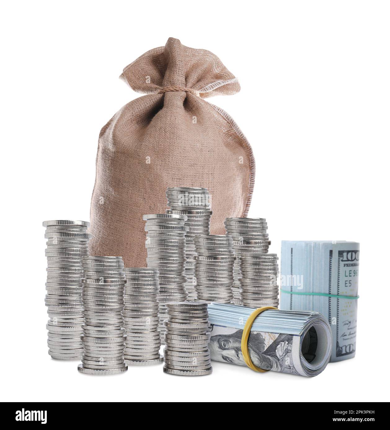 Stacked coins, dollar banknotes and sack full of money on white ...