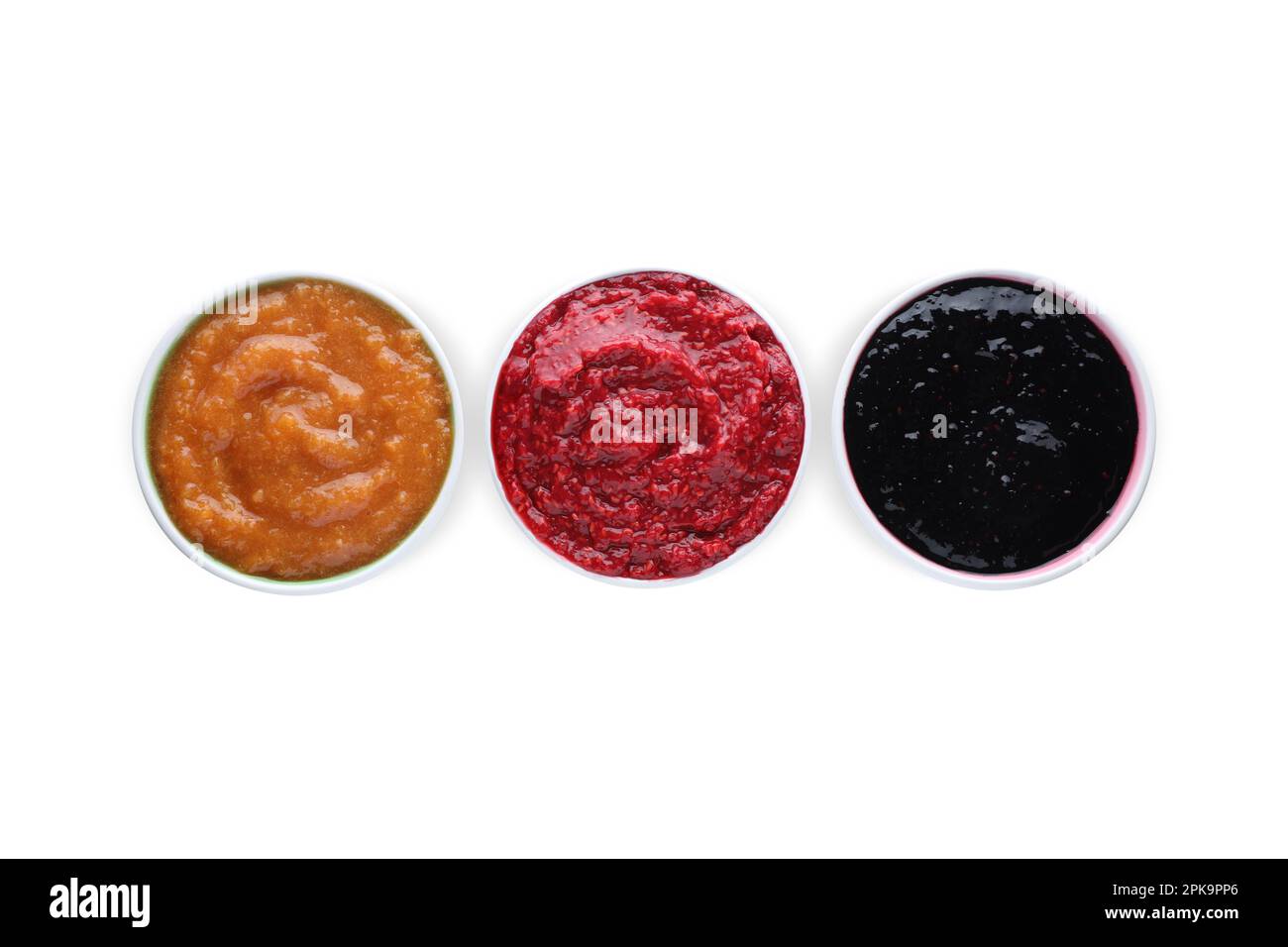 Different fruit and berry puree in bowls on white background, top view ...