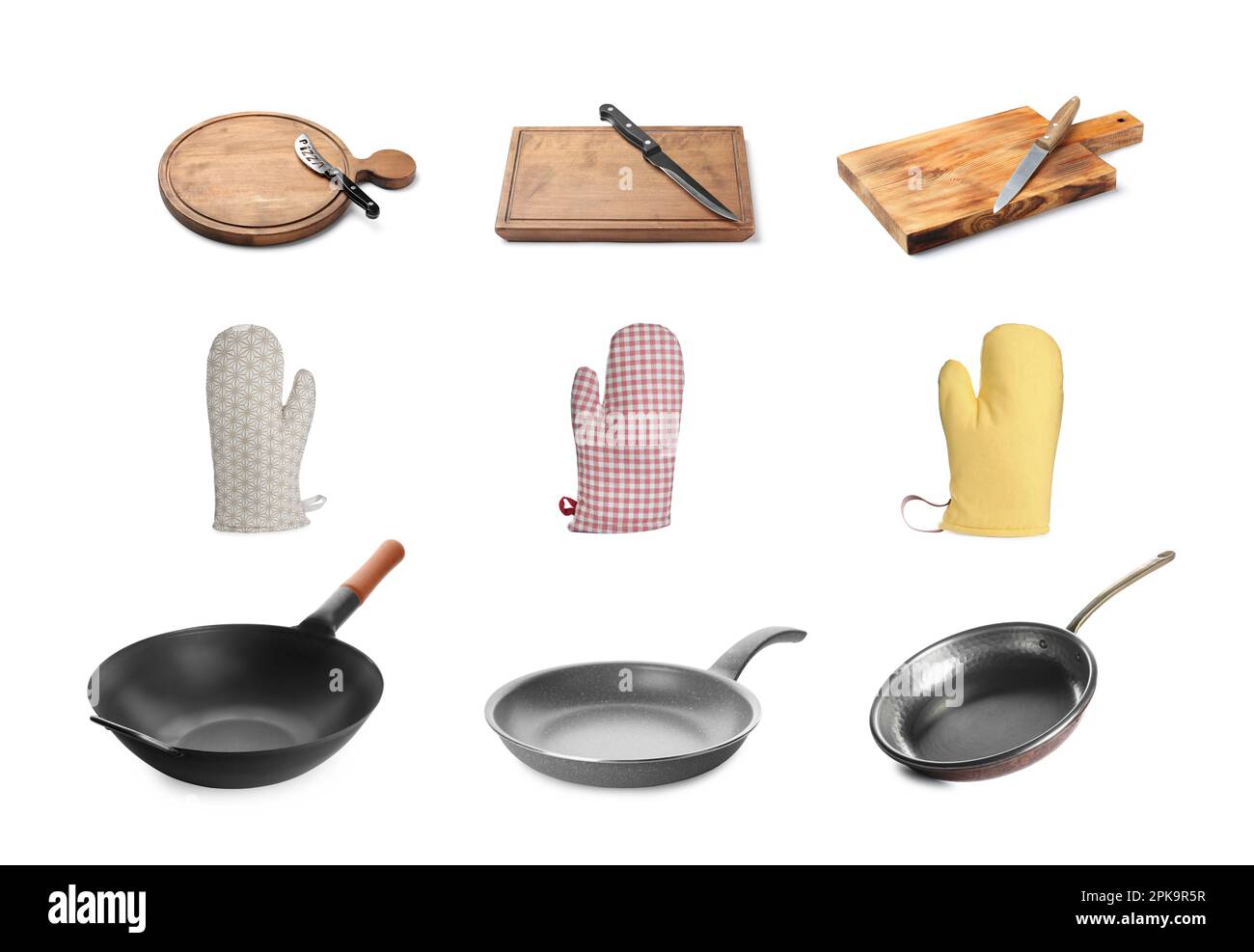Set with pans, knives with boards and gloves for hot dishes on white ...
