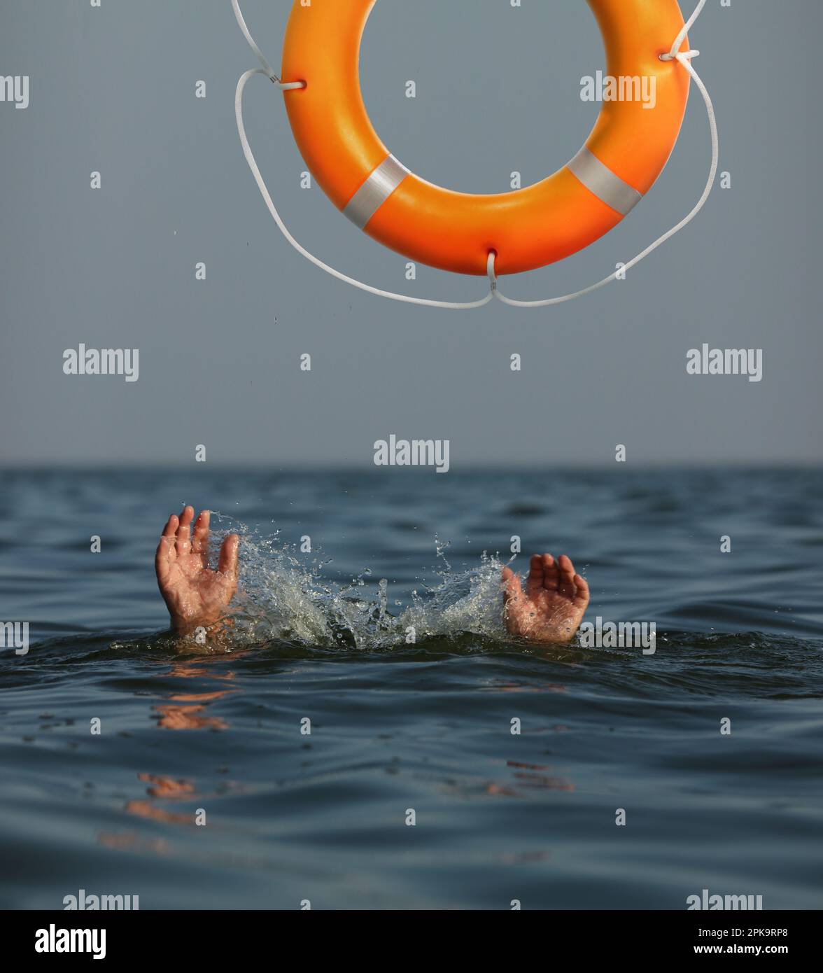 Drowning man with raised hands getting lifebelt in sea Stock Photo - Alamy