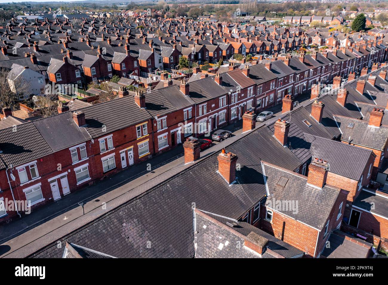 An aerial view above the rooftops of run down back to back terraced ...