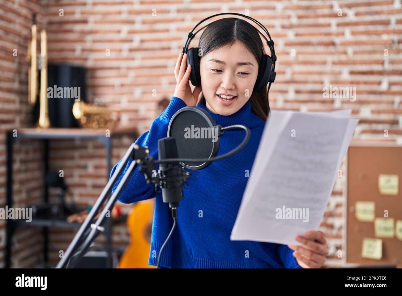 Chinese woman artist singing song at music studio Stock Photo - Alamy