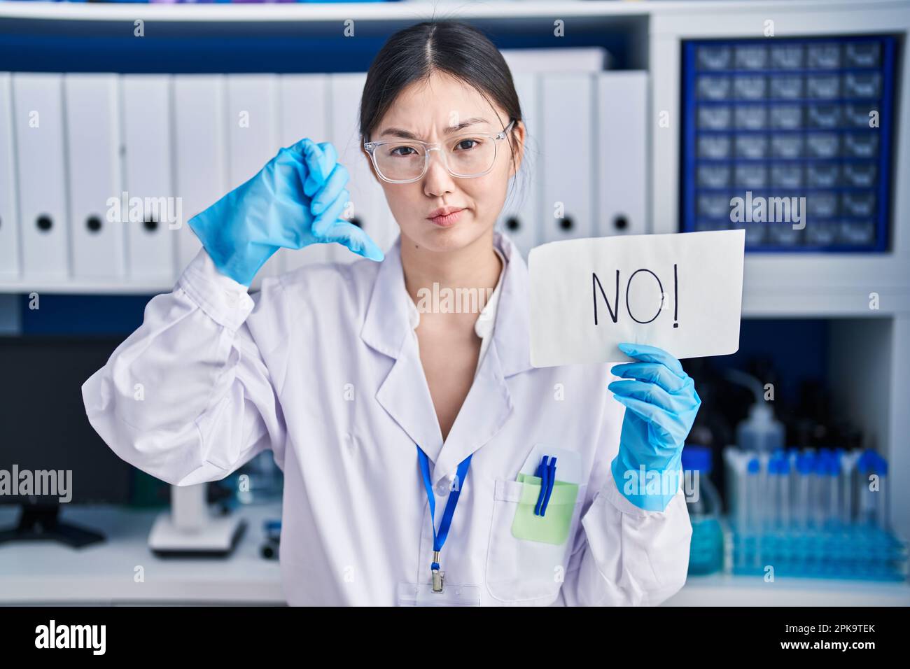 Chinese young woman working at scientist laboratory holding no banner ...