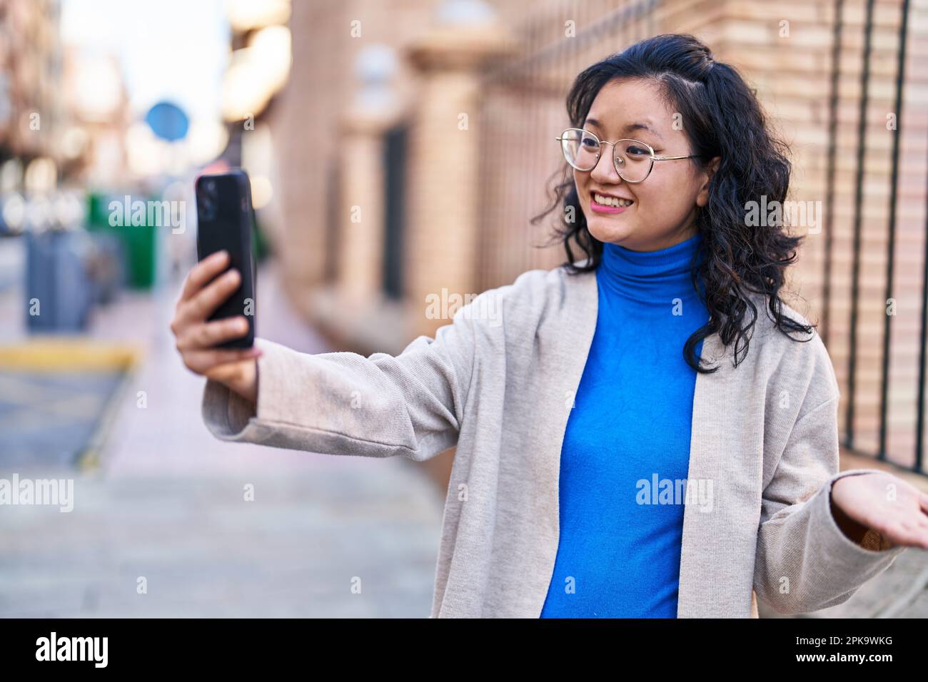 Young chinese woman smiling confident having video call at street Stock ...