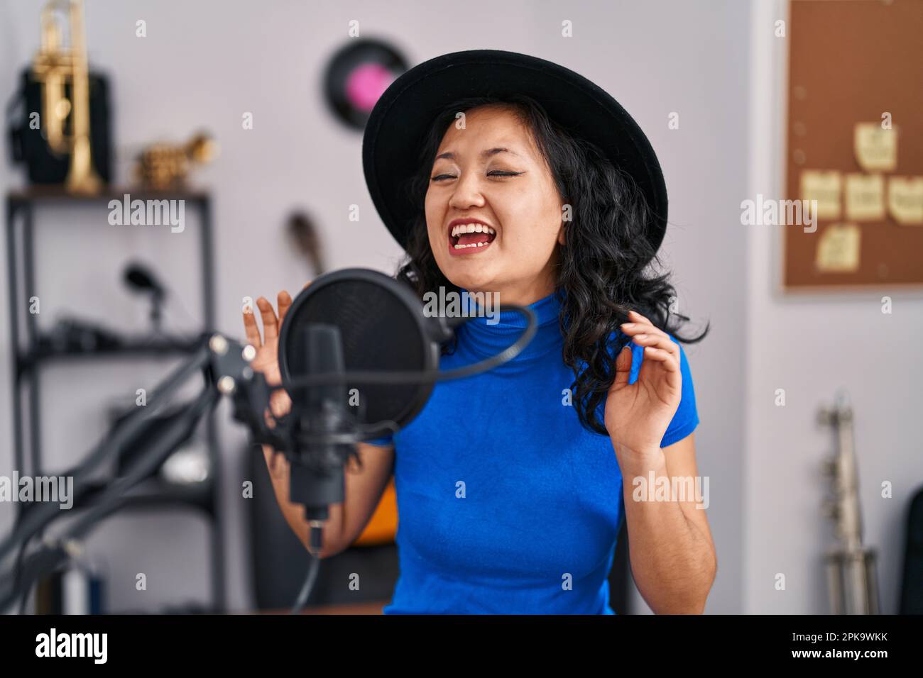 Young chinese woman artist singing song at music studio Stock Photo - Alamy