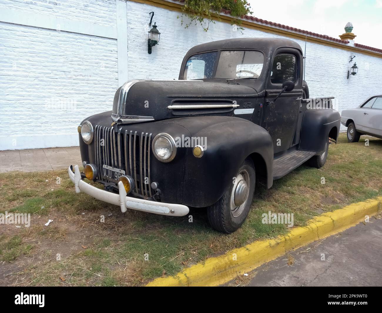 An old dirty worn Ford custom pickup truck 1942 - 1947 in the street ...
