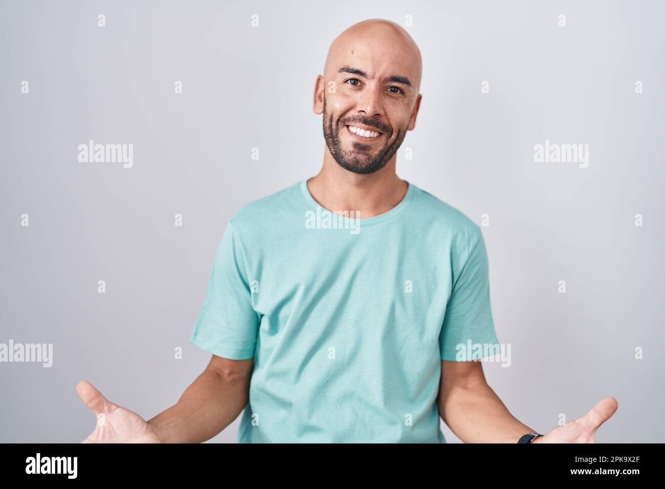 Middle age bald man standing over white background smiling cheerful ...
