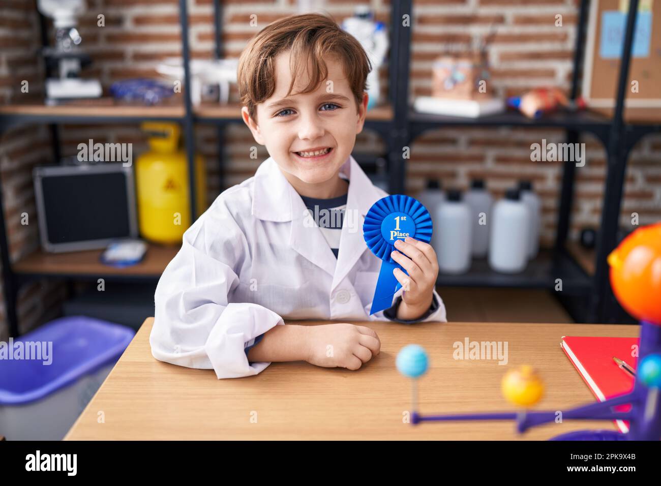 Little caucasian boy at school scientist laboratory winning first prize ...