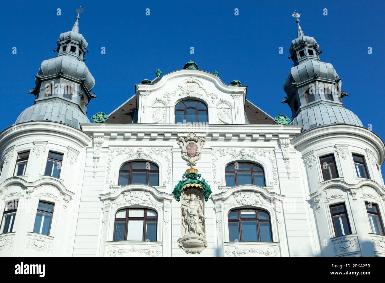 The facade with a sculpture of 19th century historic building with two ...