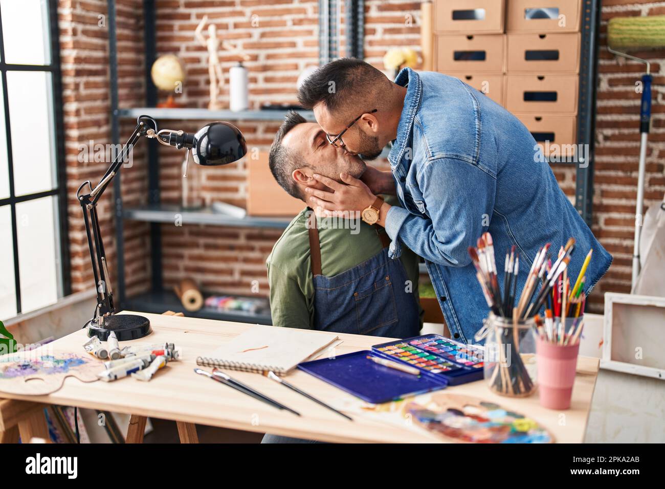 Two men artists drawing on notebook kissing at art studio Stock Photo ...