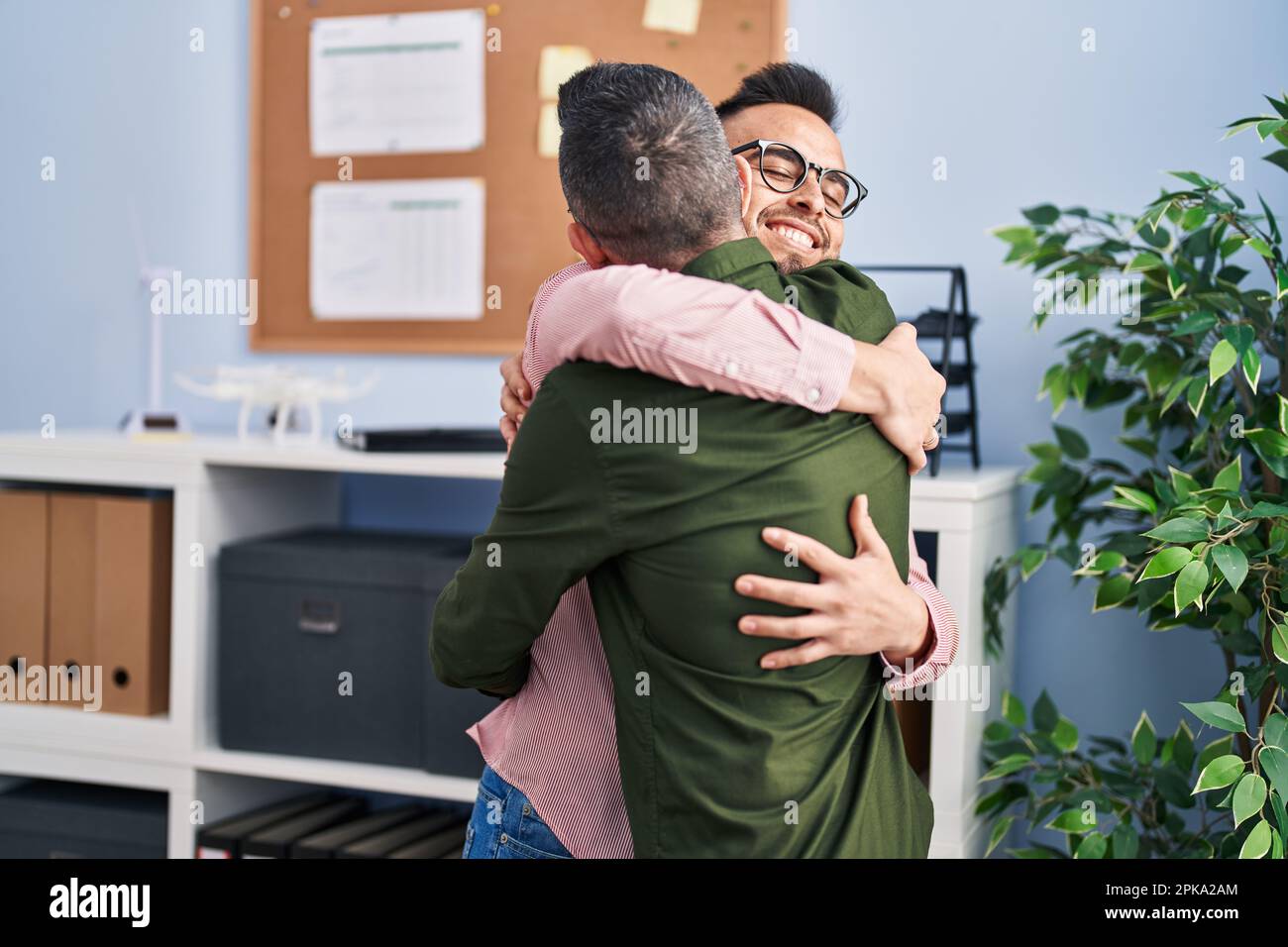 Two men business workers hugging each other at office Stock Photo - Alamy