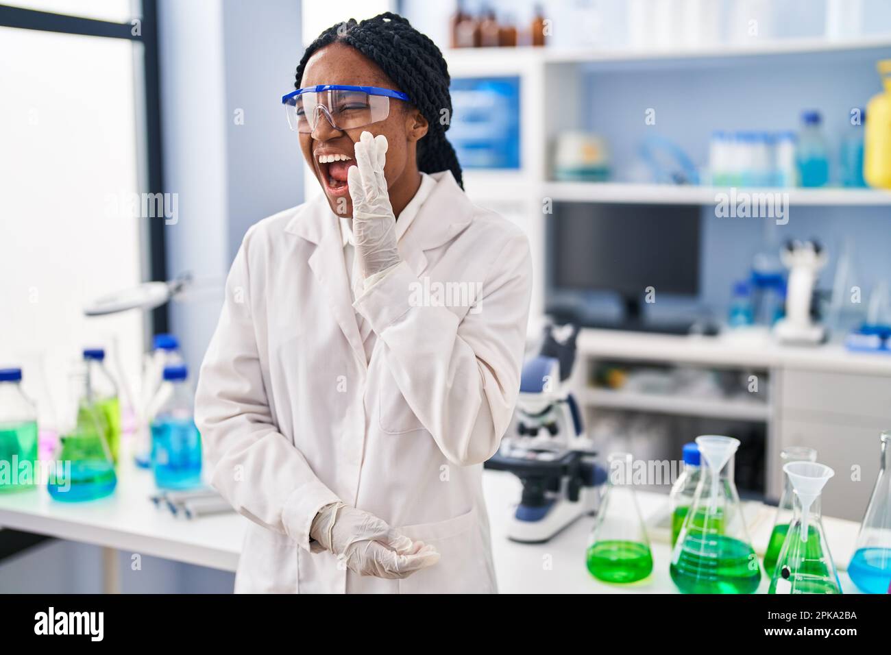 African american woman working at scientist laboratory clueless and ...