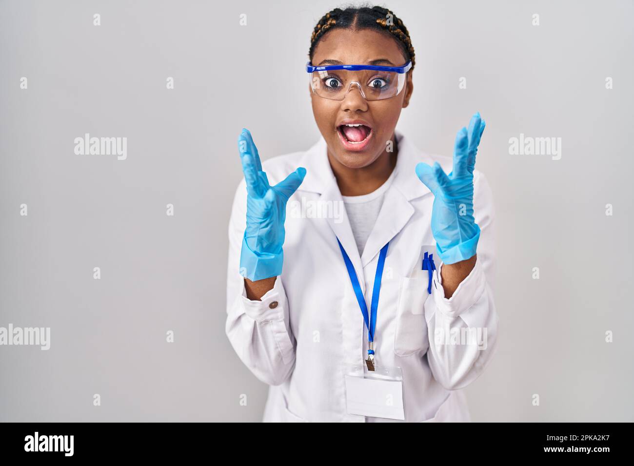 African american woman with braids wearing scientist robe celebrating ...