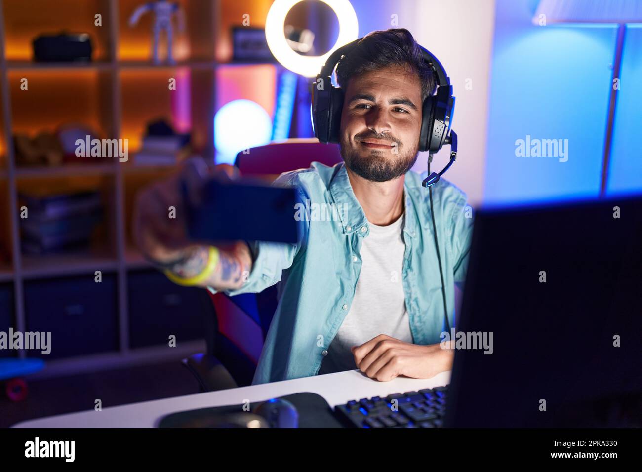 Young hispanic man streamer smiling confident make selfie by smartphone ...