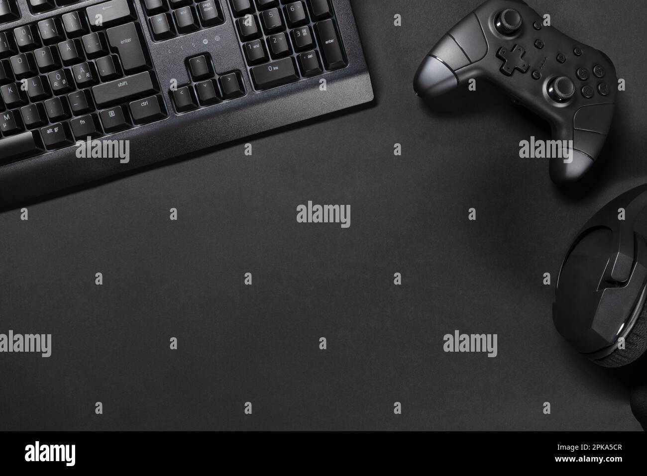 Directly above view of gaming desk with keyboard by game controller and ...