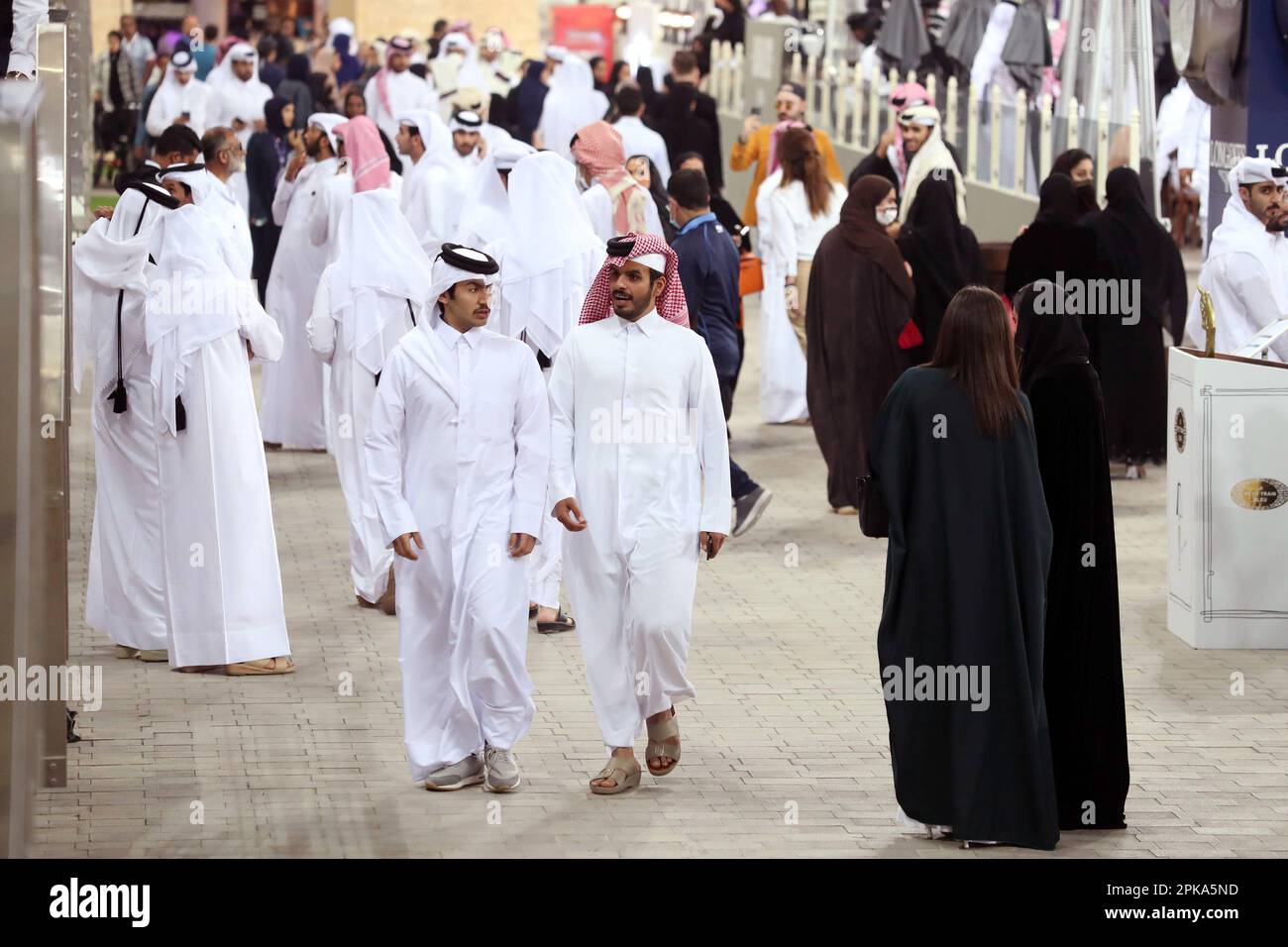26.02.2022, Qatar, , Doha - People in traditional garments in the city ...