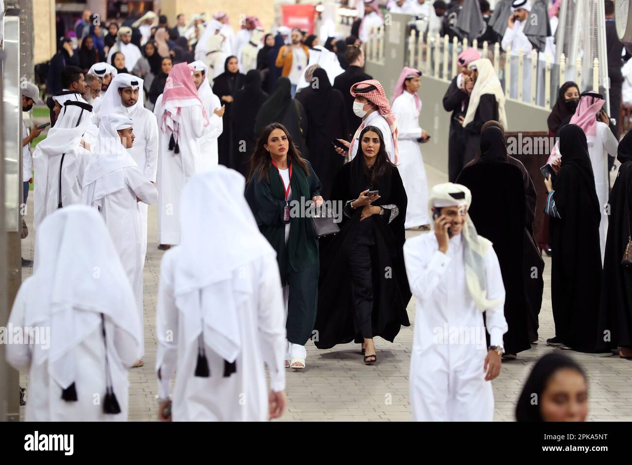 26.02.2022, Qatar, , Doha - People in traditional garments in the city ...