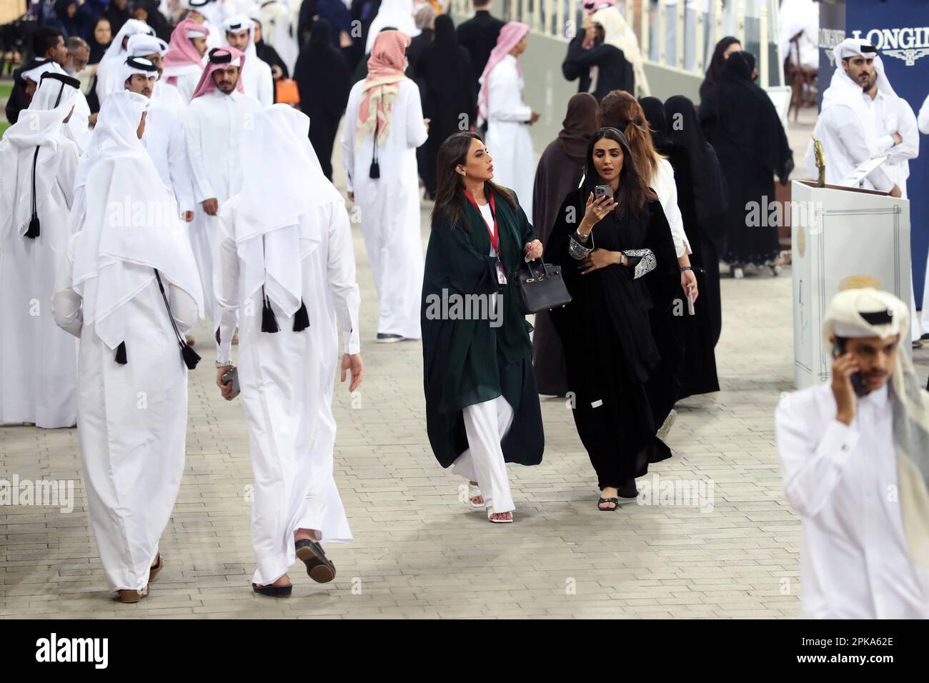 26.02.2022, Qatar, , Doha - People in traditional garments in the city ...