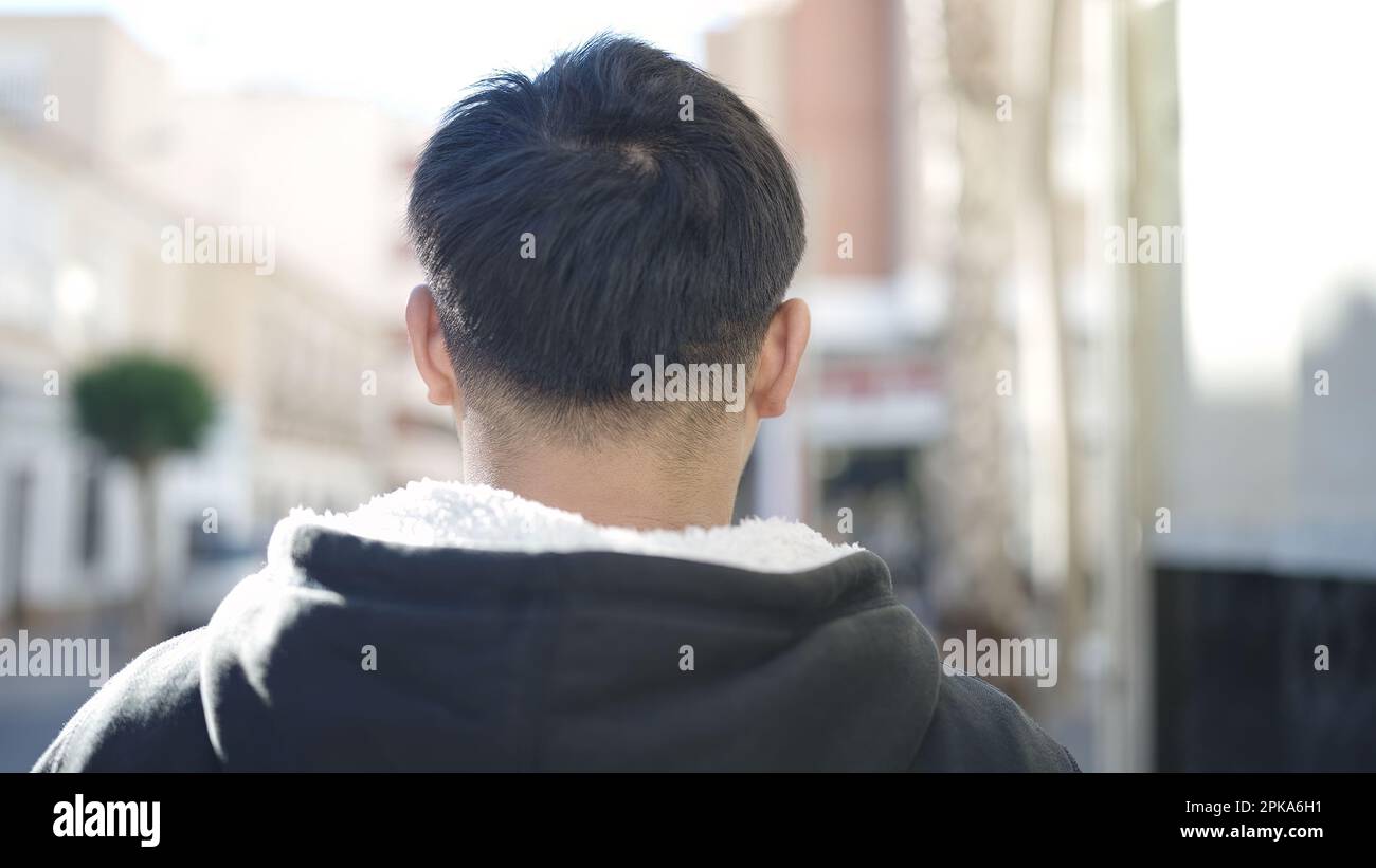 Young chinese man standing on back view at street Stock Photo - Alamy