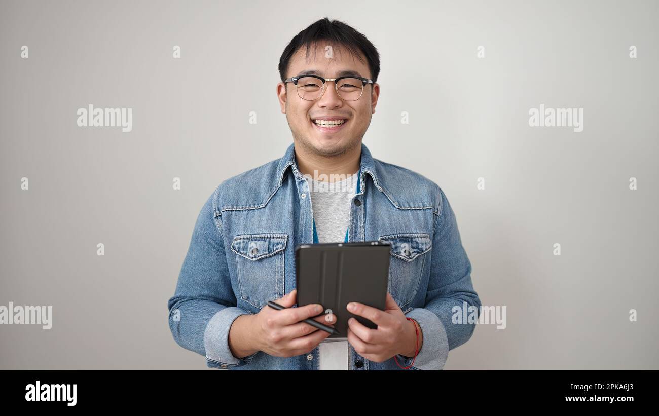 Young chinese man smiling confident using touchpad over isolated white ...