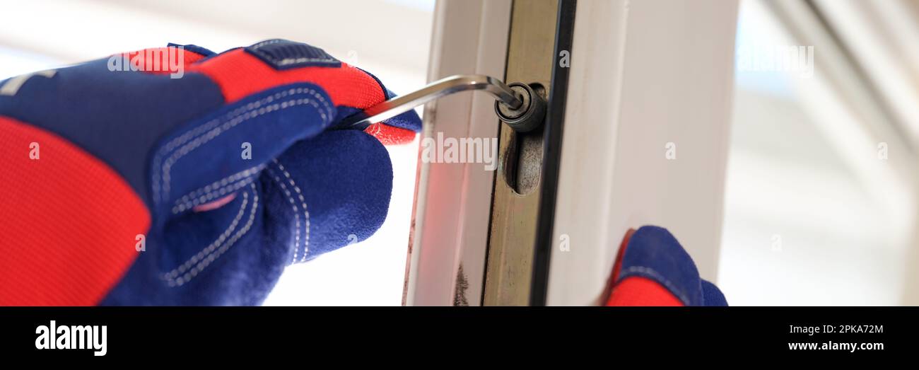 Master in gloves adjusting locks of pvc windows with special key Stock ...