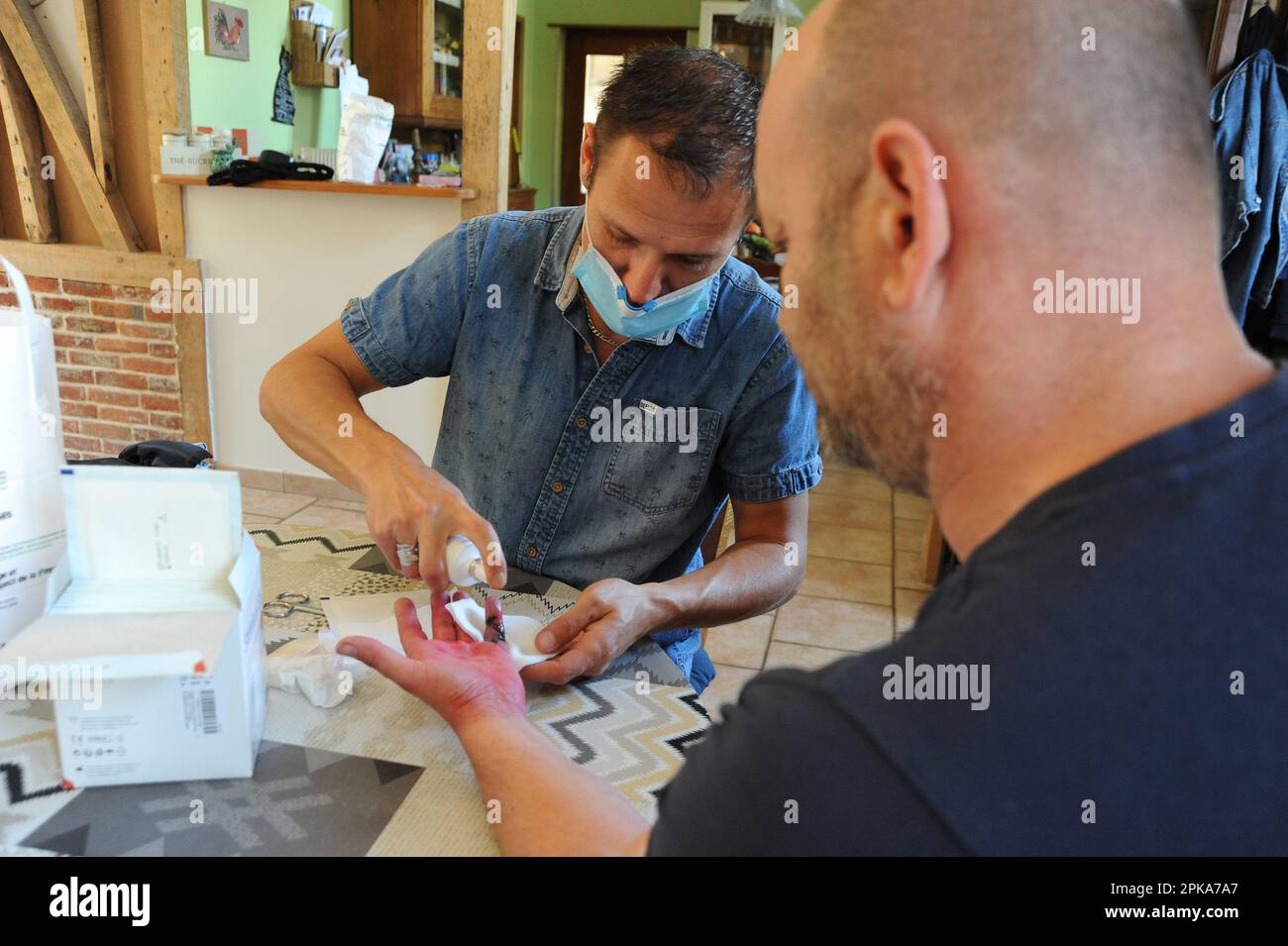 Home nurse for a post-operative dressing on a trigger finger Stock ...