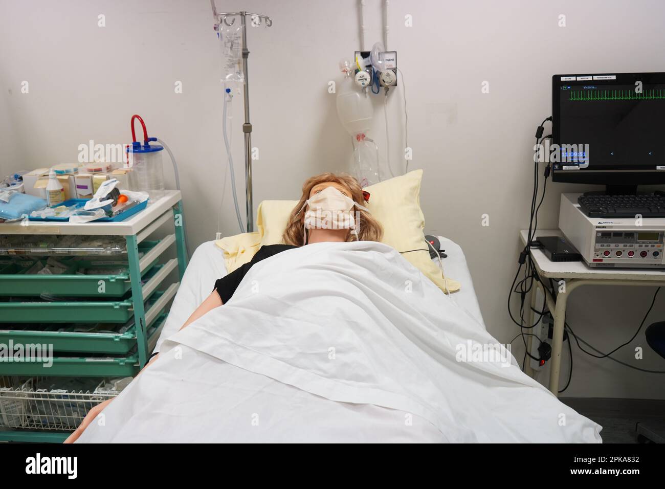 Students facing a post natal emergency follow procedures on a mannequin ...