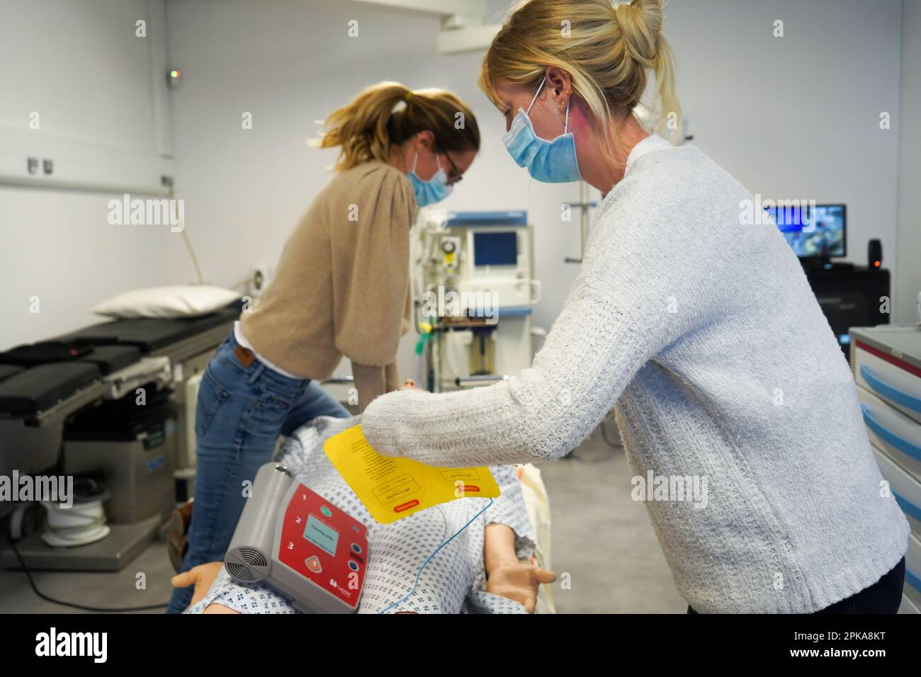 Resuscitation training on a dummy: cardiac massage and defibrillator Stock Photo - Alamy