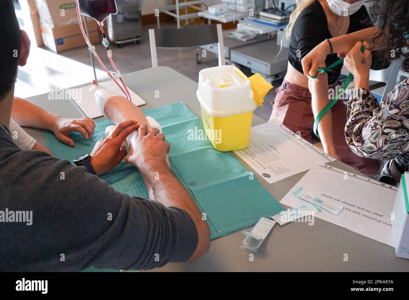 5th year medical students during an IV placement workshop. Students ...