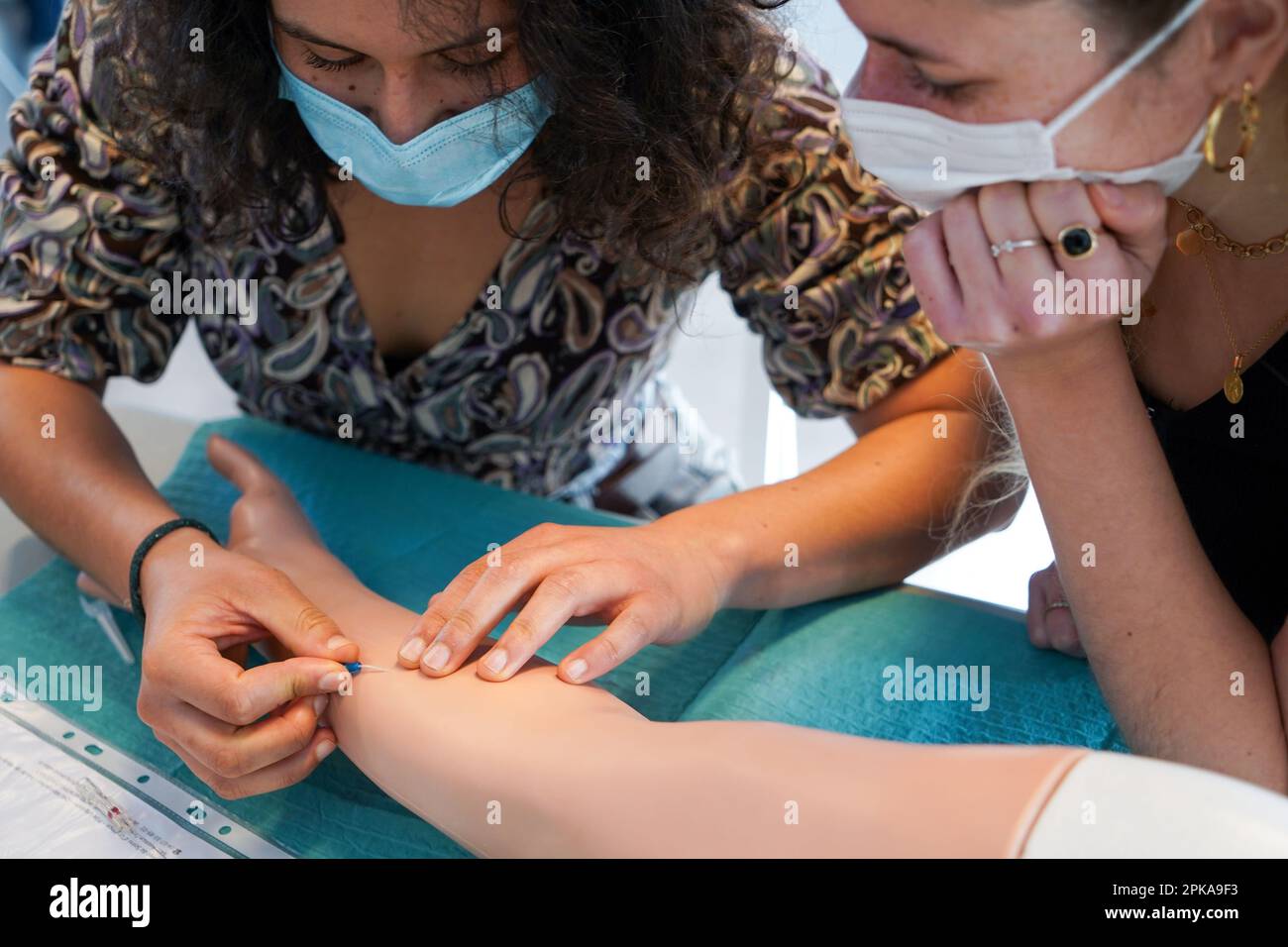 5th year medical students during an IV placement workshop. Students ...